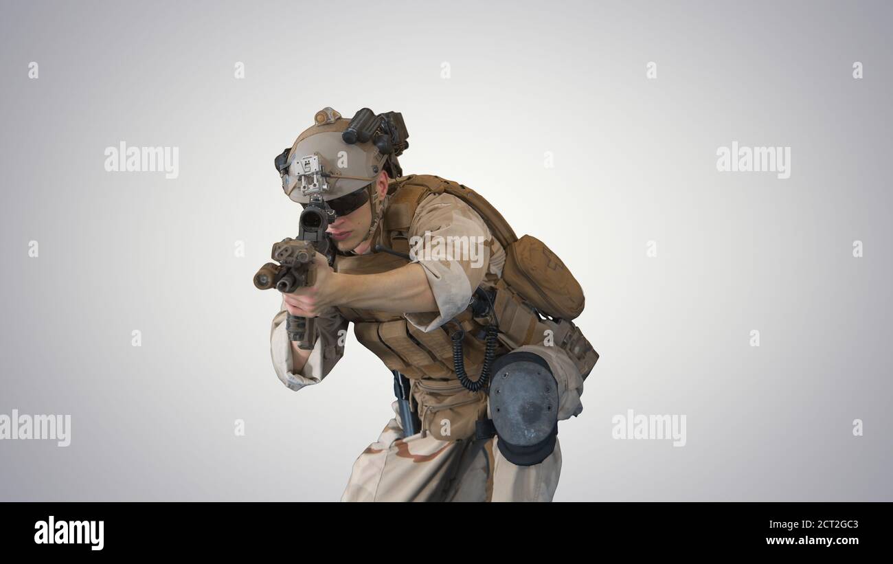 US military marine shooting from sitting position on gradient ba Stock ...