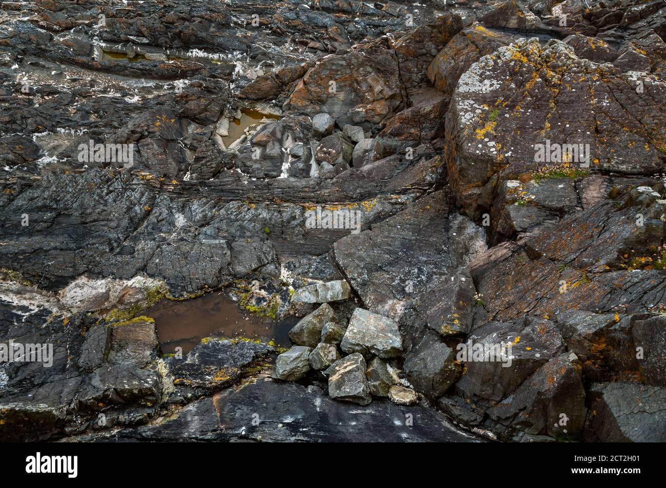 Barnacle-covered rocks and small rockpools at Peel, Isle of Man Stock ...