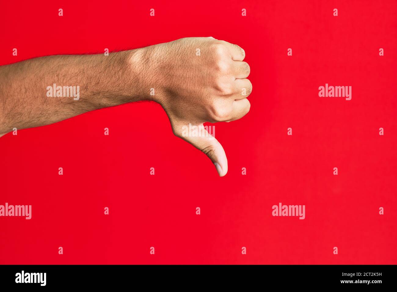 Arm of caucasian white young man over red isolated background doing ...