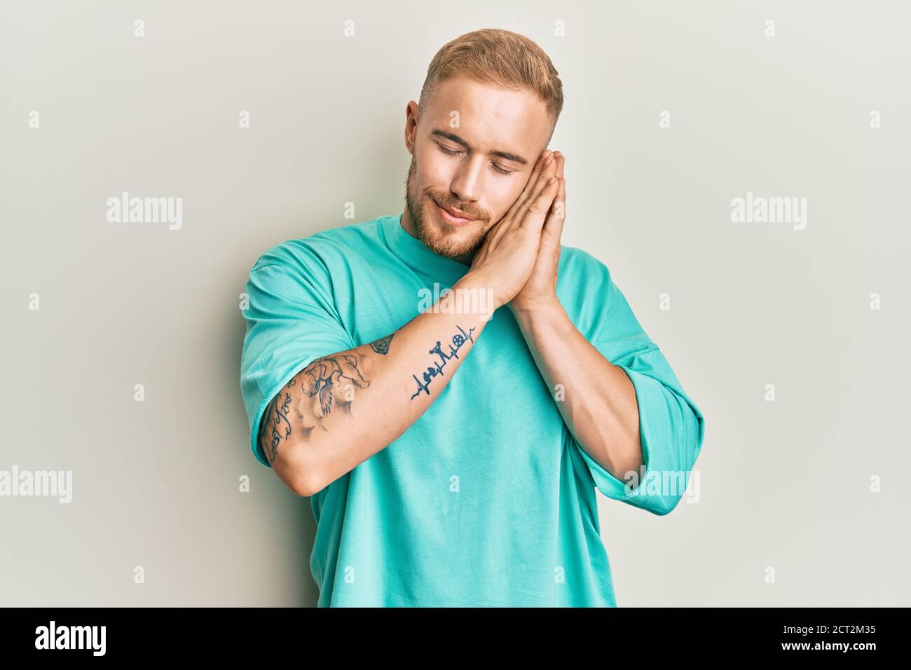 Young Caucasian Man Wearing Casual Clothes Sleeping Tired Dreaming And