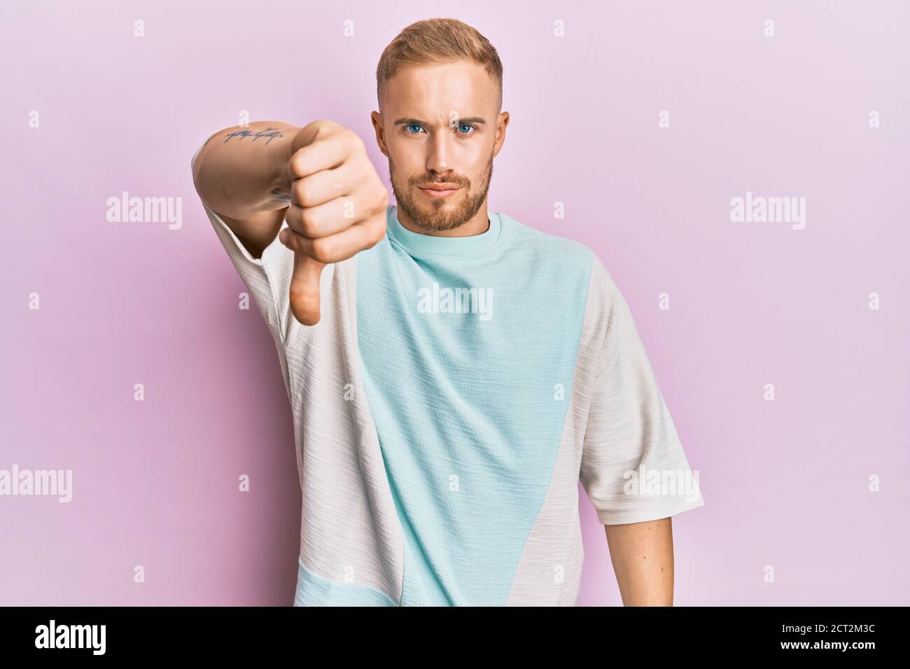 Young caucasian man wearing casual clothes looking unhappy and angry ...