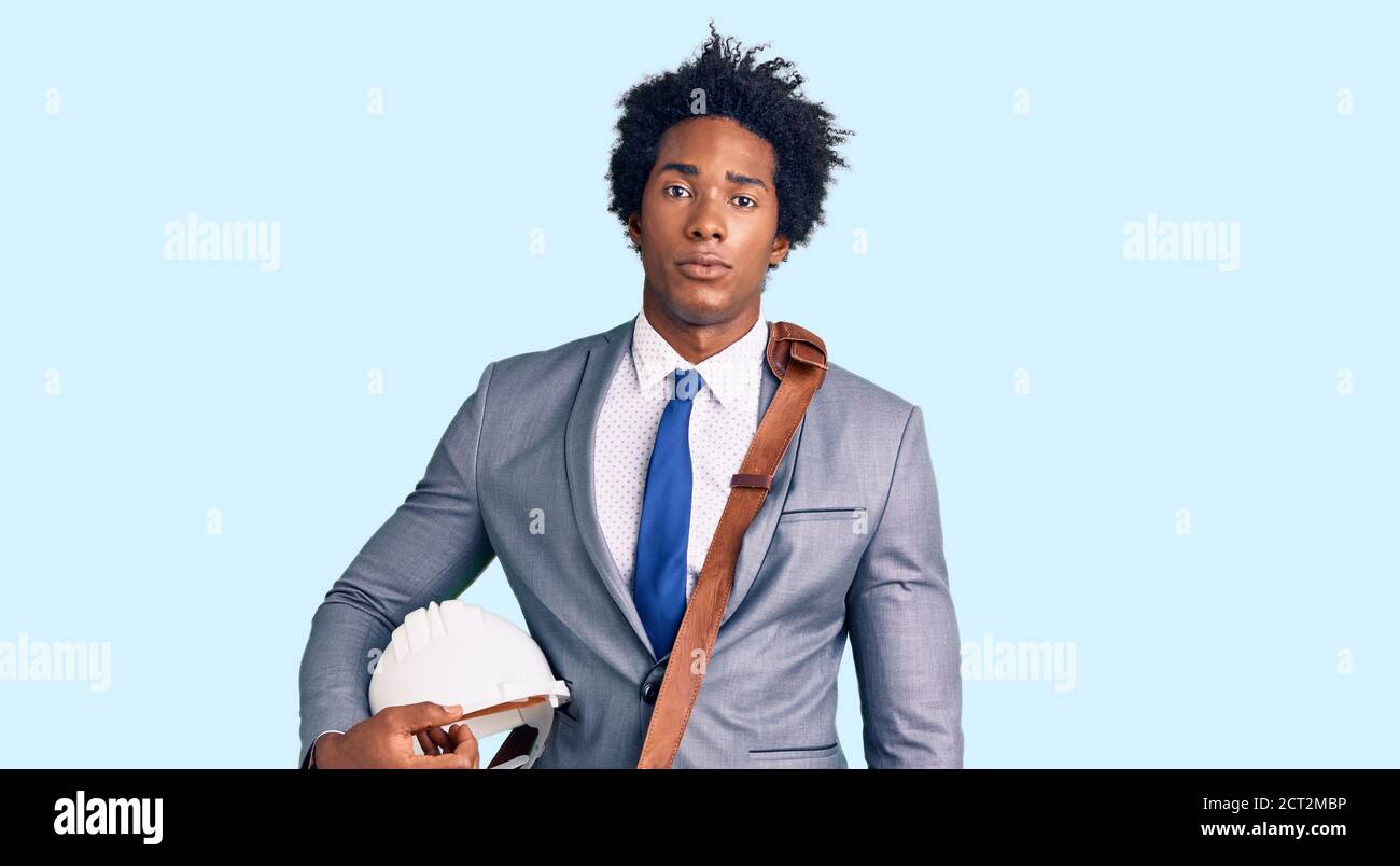 Handsome african american man with afro hair holding architect hardhat ...