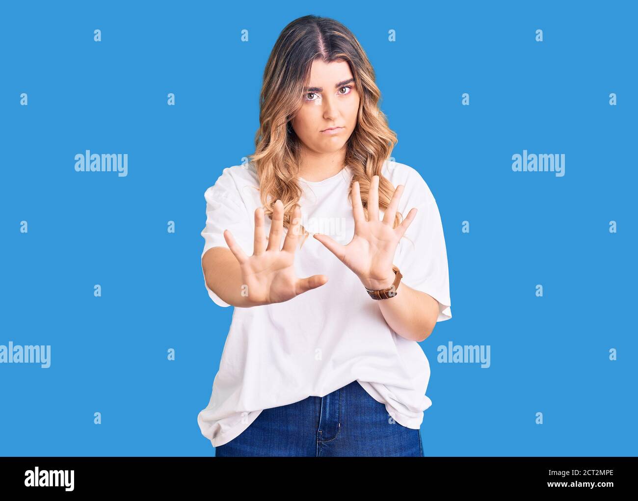 Young caucasian woman wearing casual clothes moving away hands palms ...