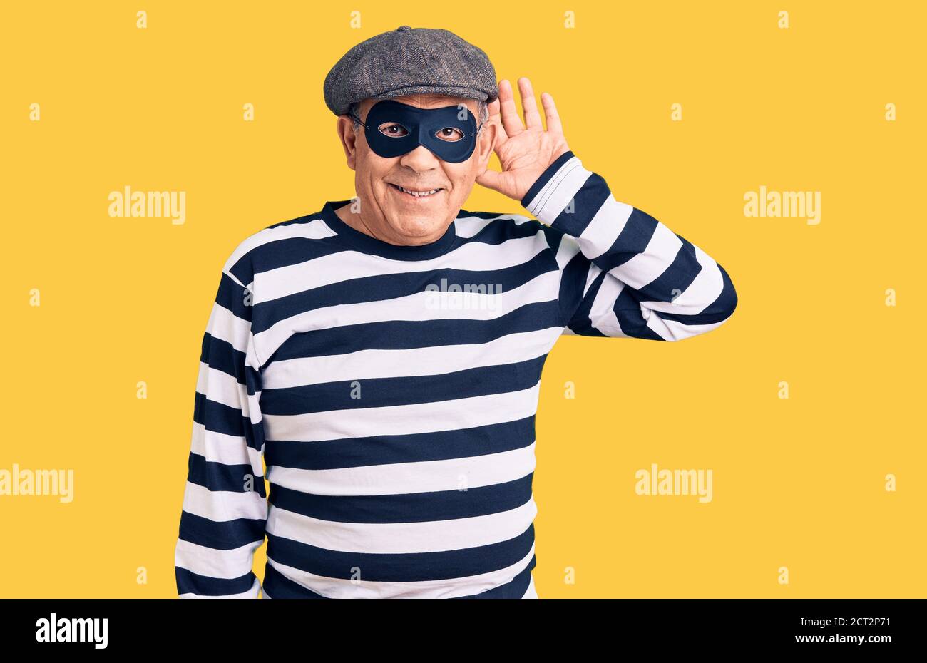 Senior handsome man wearing burglar mask and t-shirt smiling with hand ...
