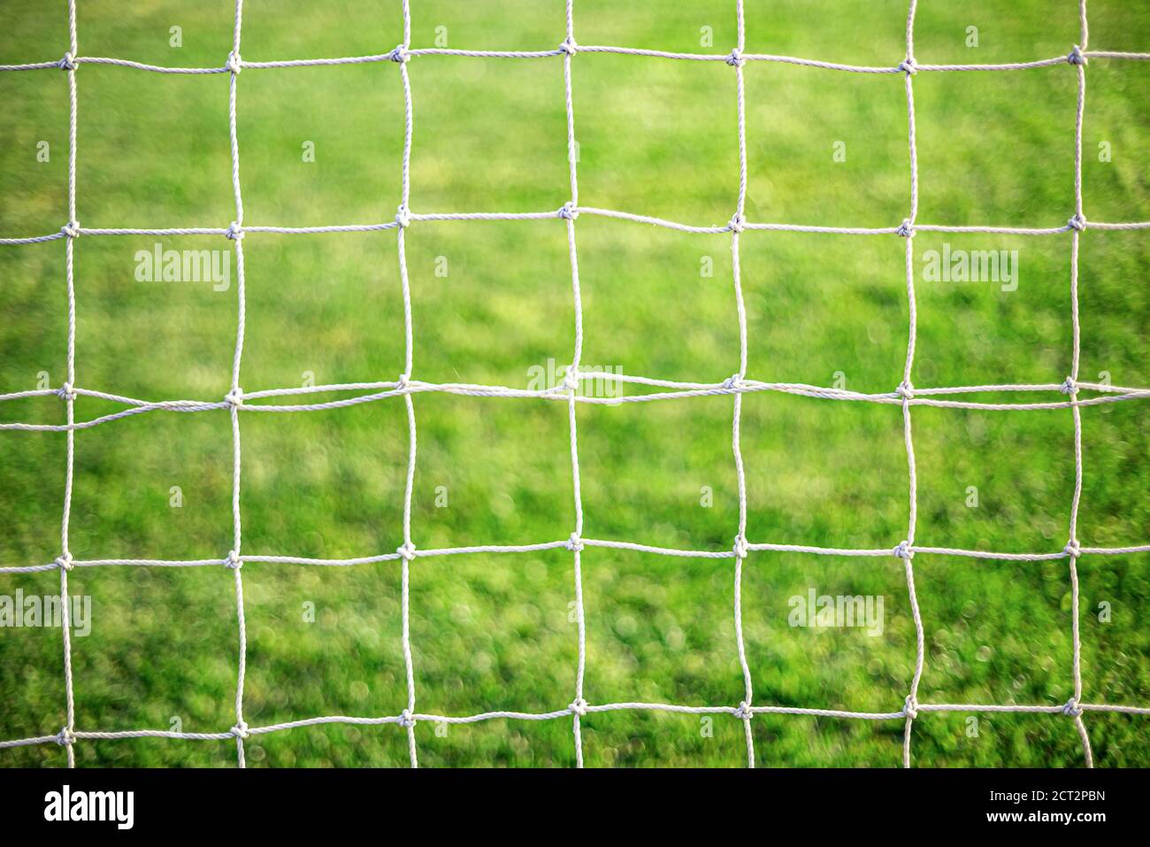 White soccer goal net on grass background Stock Photo - Alamy