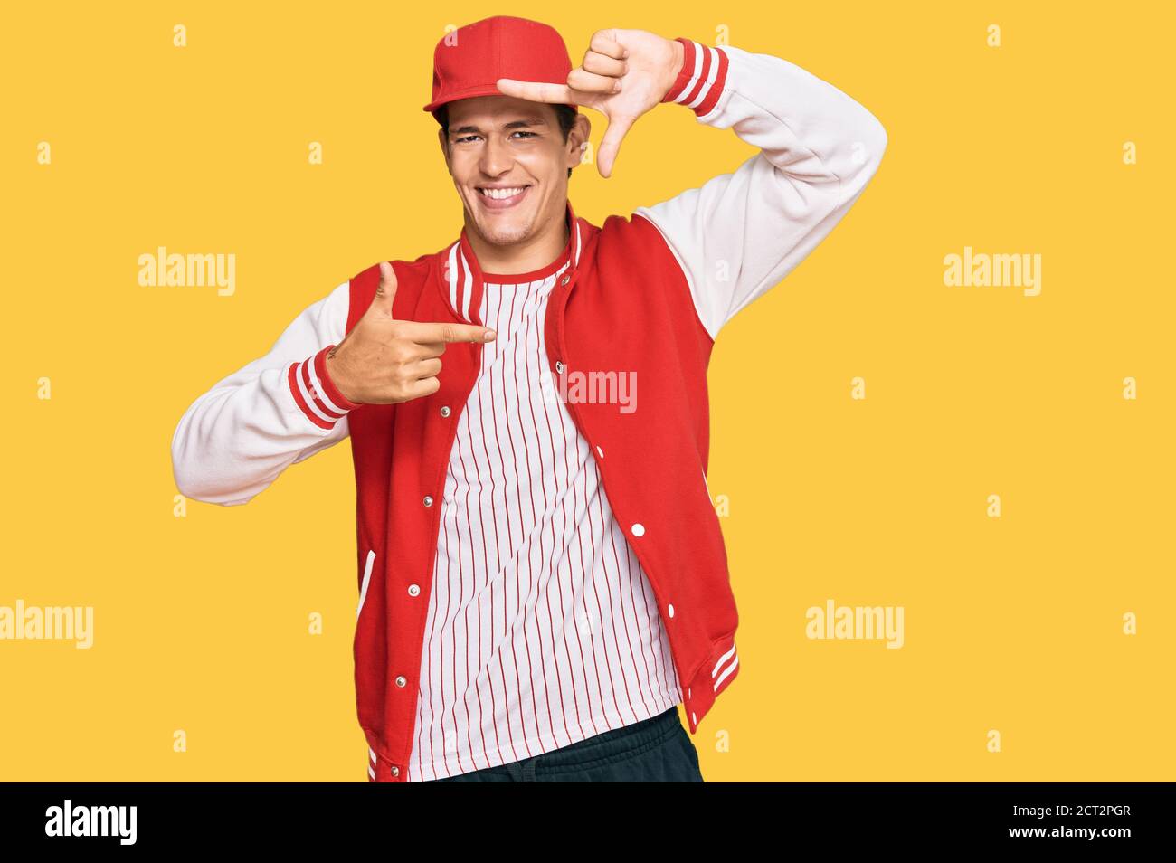 Handsome caucasian man wearing baseball uniform smiling making frame ...