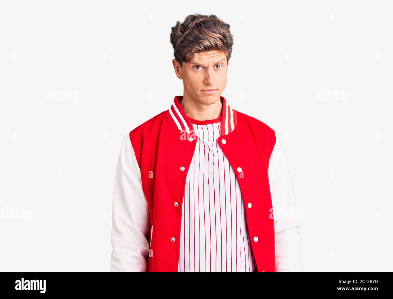 Young handsome man wearing baseball uniform skeptic and nervous ...