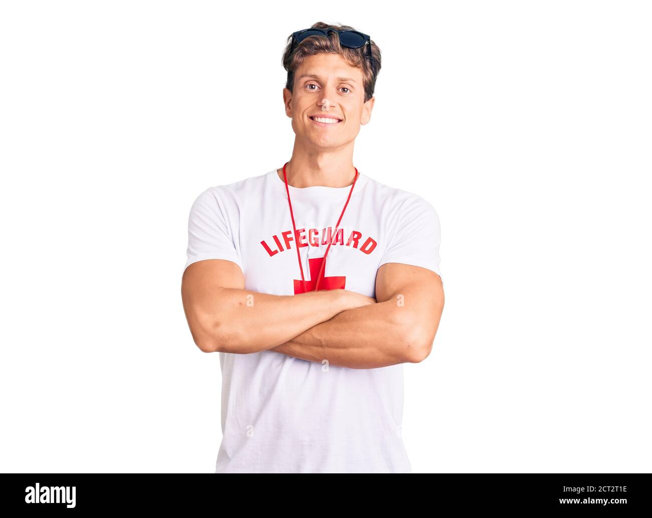 Young handsome man wearing lifeguard t shirt and whistle happy face ...