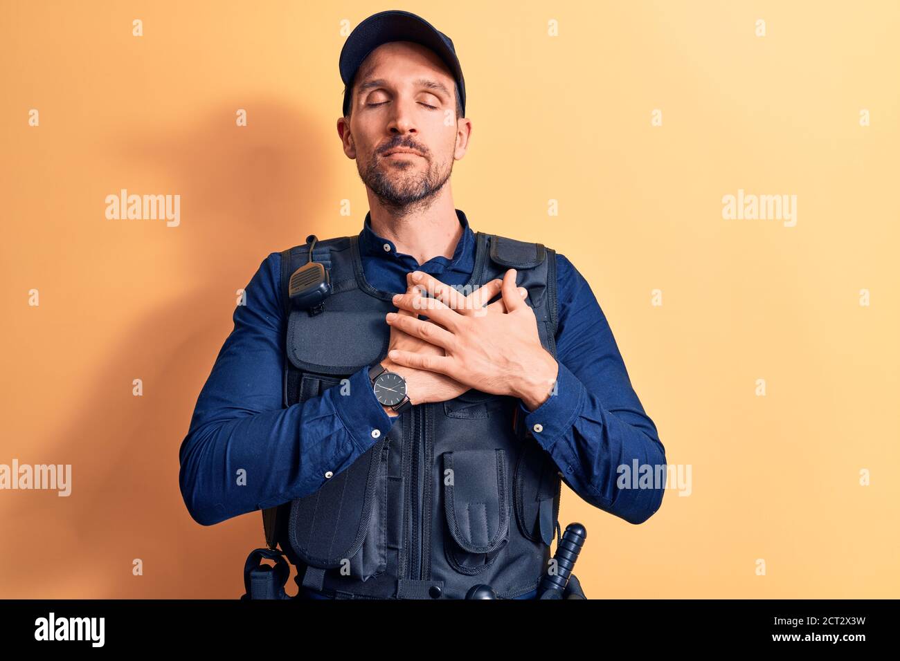 Young handsome policeman wearing police uniform and bulletprof over ...