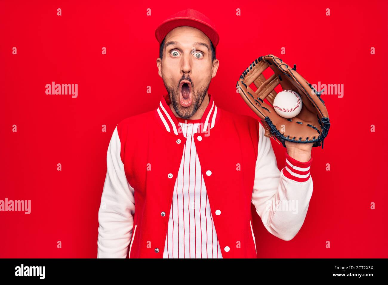 Young handsome player man wearing sportswear playing baseball using ...