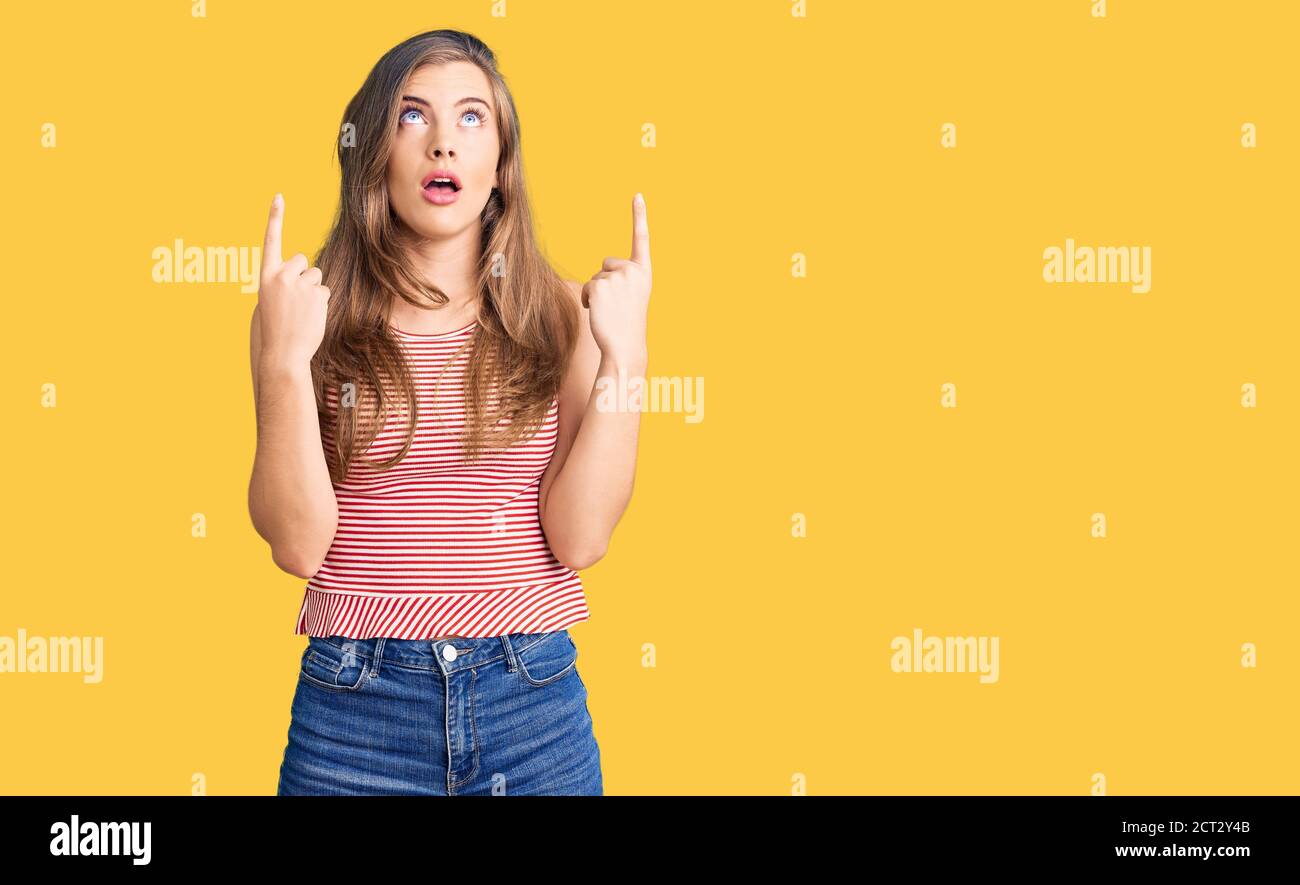 Beautiful caucasian young woman wearing casual clothes amazed and ...