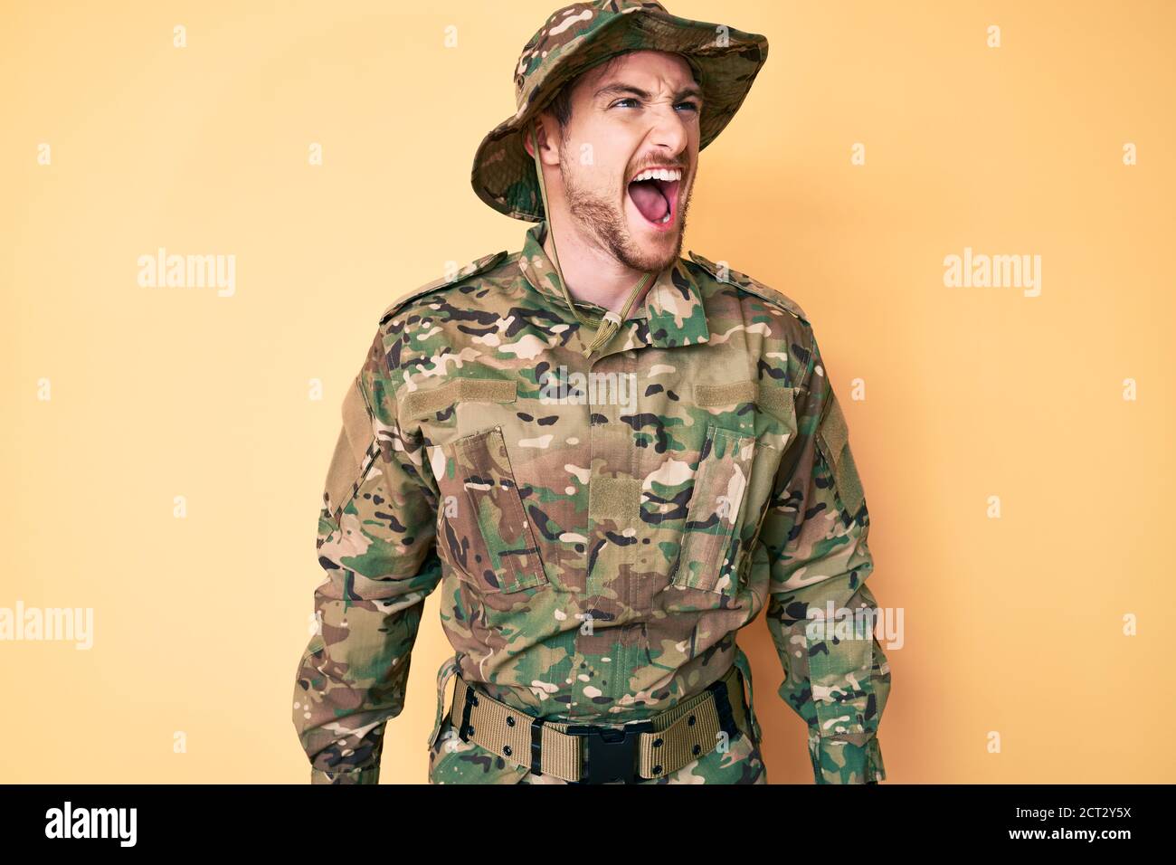 Young caucasian man wearing camouflage army uniform angry and mad ...