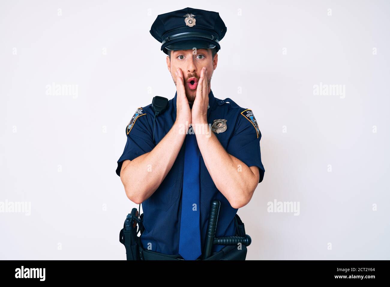 Young caucasian man wearing police uniform afraid and shocked, surprise ...