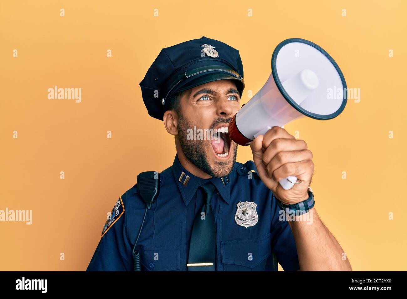 American police officer shouting through megaphone, yelling and ...
