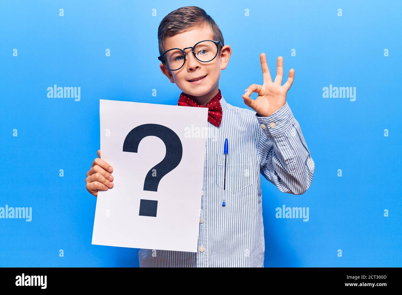 Cute blond kid wearing nerd bow tie and glasses holding question mark ...