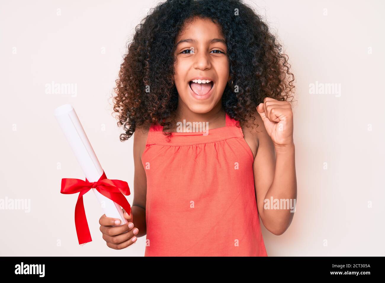 African american child with curly hair holding graduate degree diploma ...