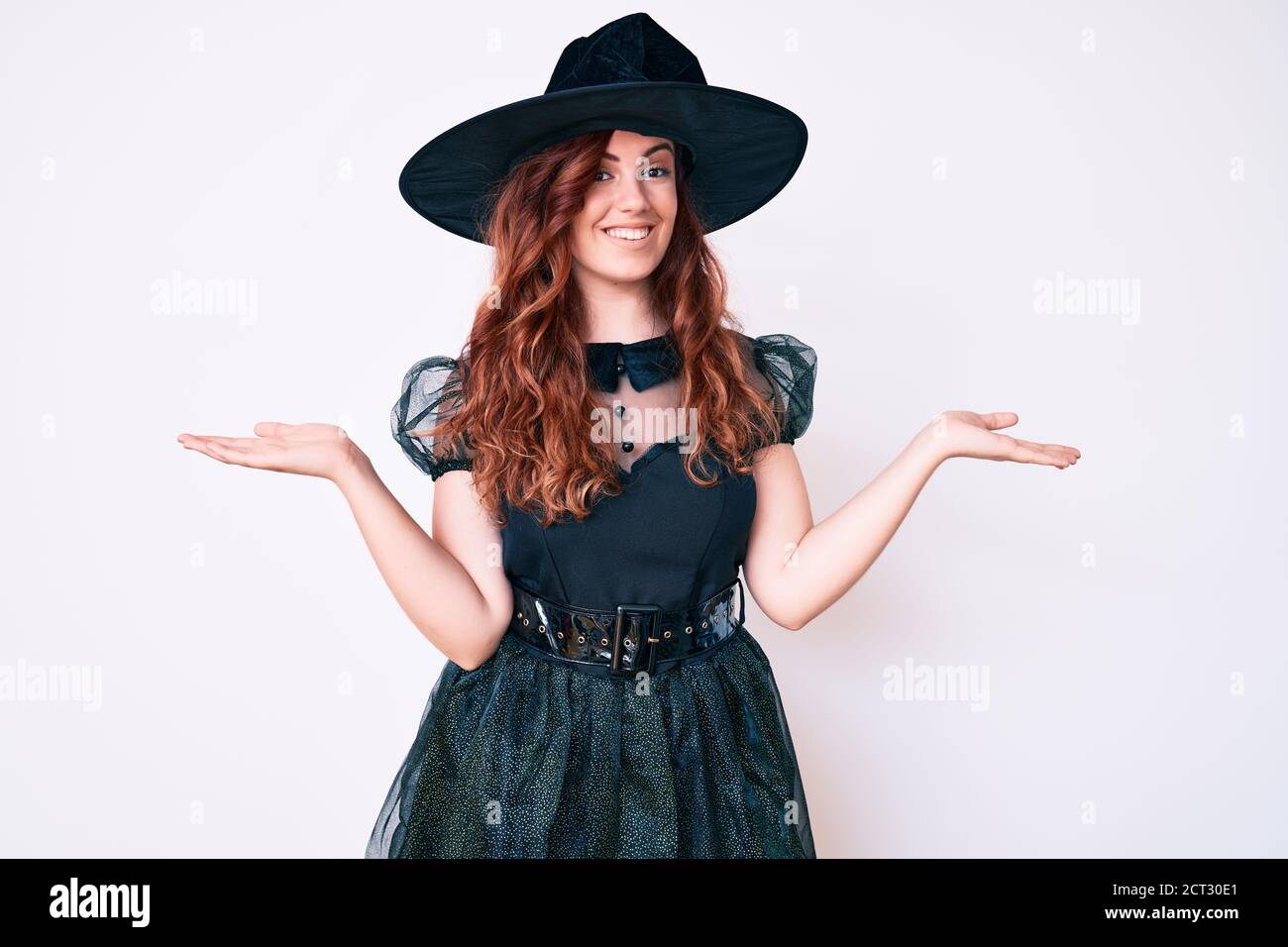 Young beautiful woman wearing witch halloween costume smiling showing ...