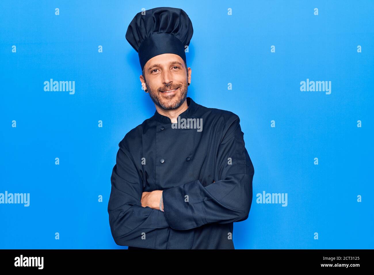 Young handsome man wearing cooker uniform happy face smiling with ...