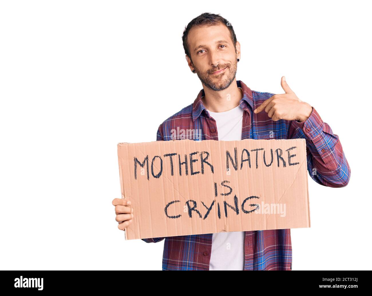 Young handsome man holding mother nature is crying protest cardboard ...