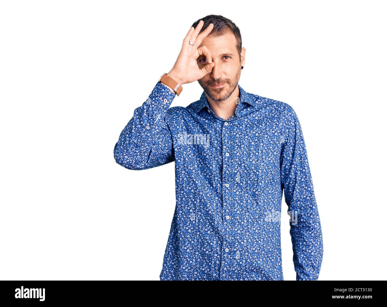 Young handsome man wearing casual clothes doing ok gesture with hand ...