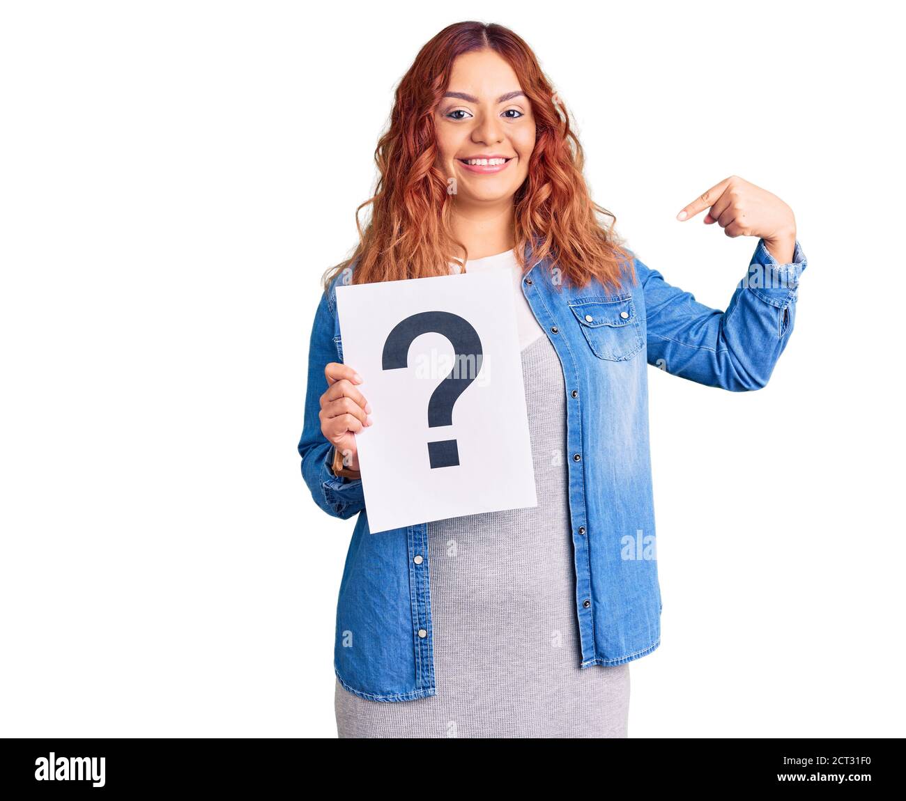 Young latin woman holding question mark pointing finger to one self ...