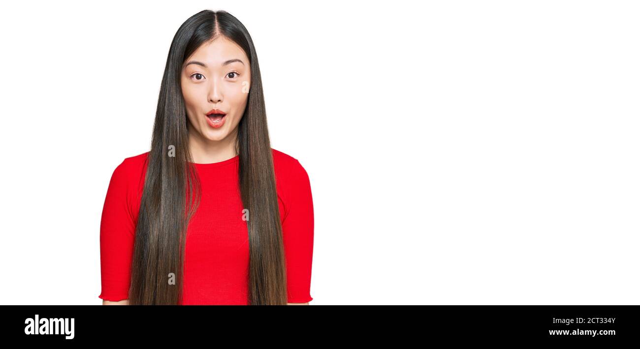 Young chinese woman wearing casual clothes afraid and shocked with ...