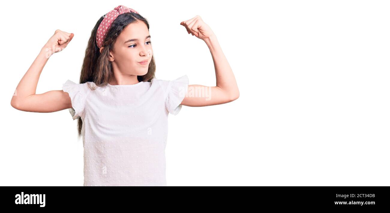 Cute hispanic child girl wearing casual white tshirt showing arms ...