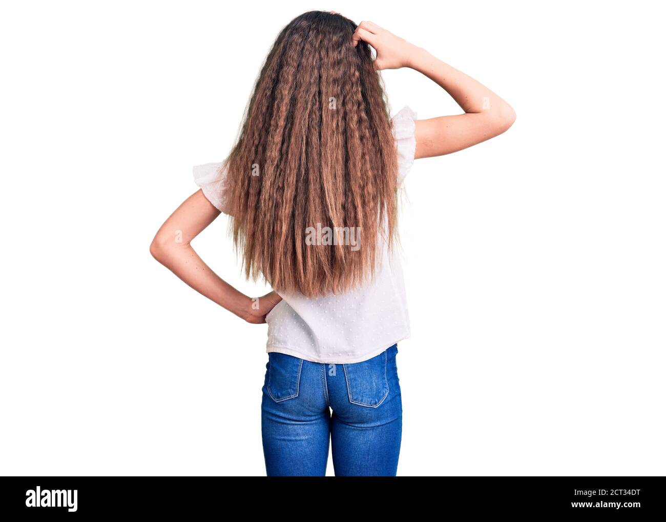 Cute hispanic child girl wearing casual white tshirt backwards thinking ...