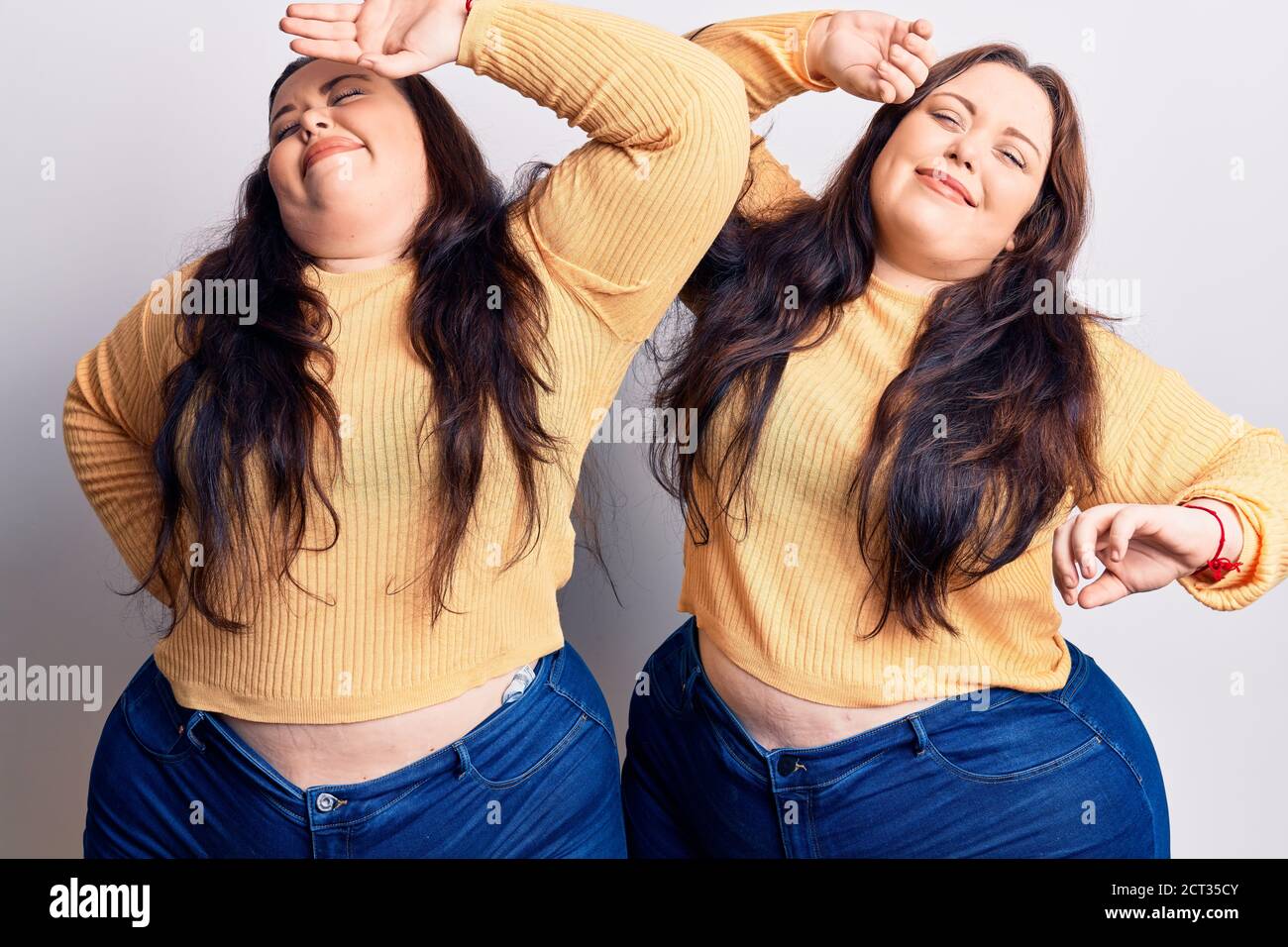 Young plus size twins wearing casual clothes stretching back, tired and ...
