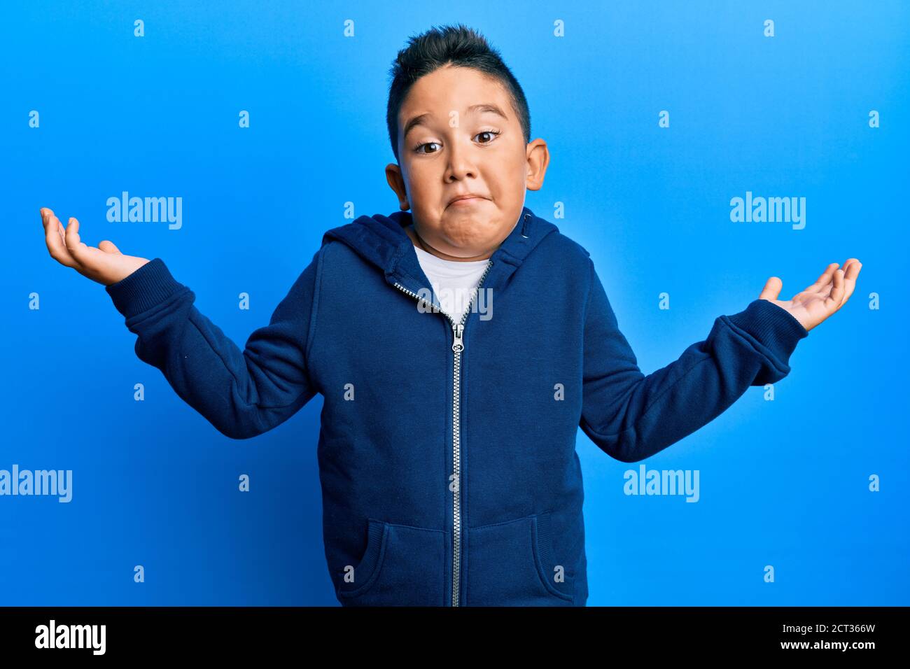 Little boy hispanic kid wearing casual sporty jacket clueless and ...