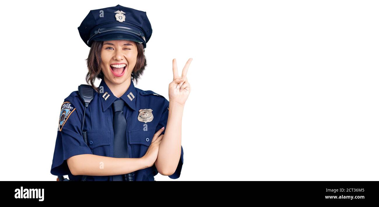 Young beautiful girl wearing police uniform smiling with happy face ...