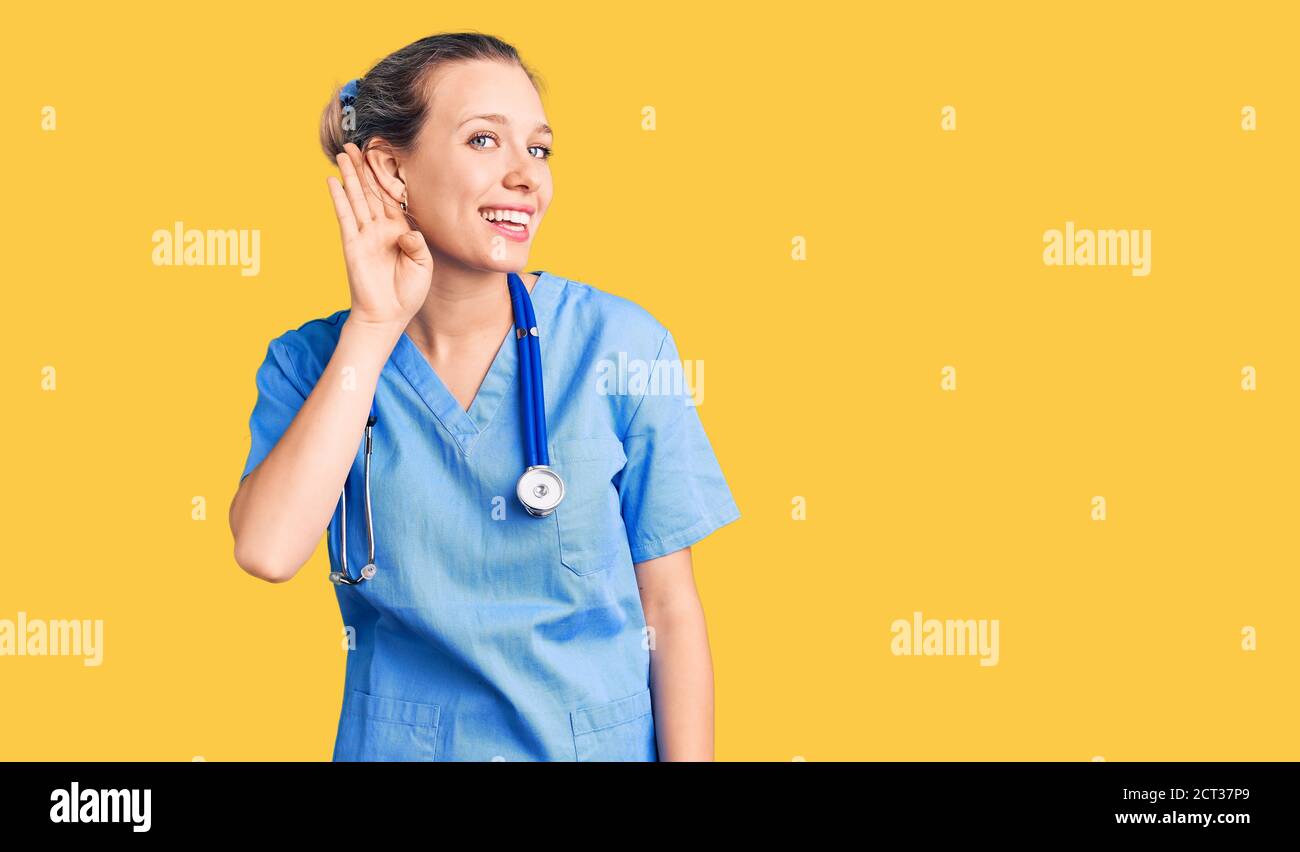 Young beautiful blonde woman wearing doctor uniform and stethoscope ...