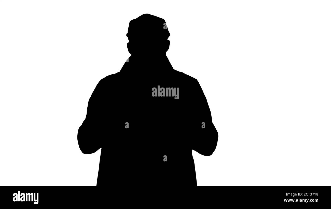 Silhouette Good looking man talking to camera and walking. Think Stock ...