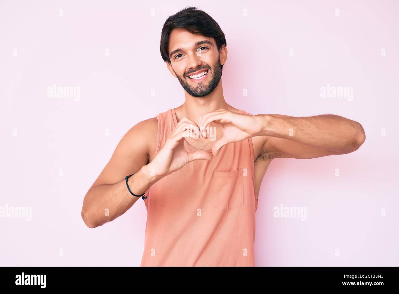 Handsome hispanic man wearing casual clothes smiling in love doing ...