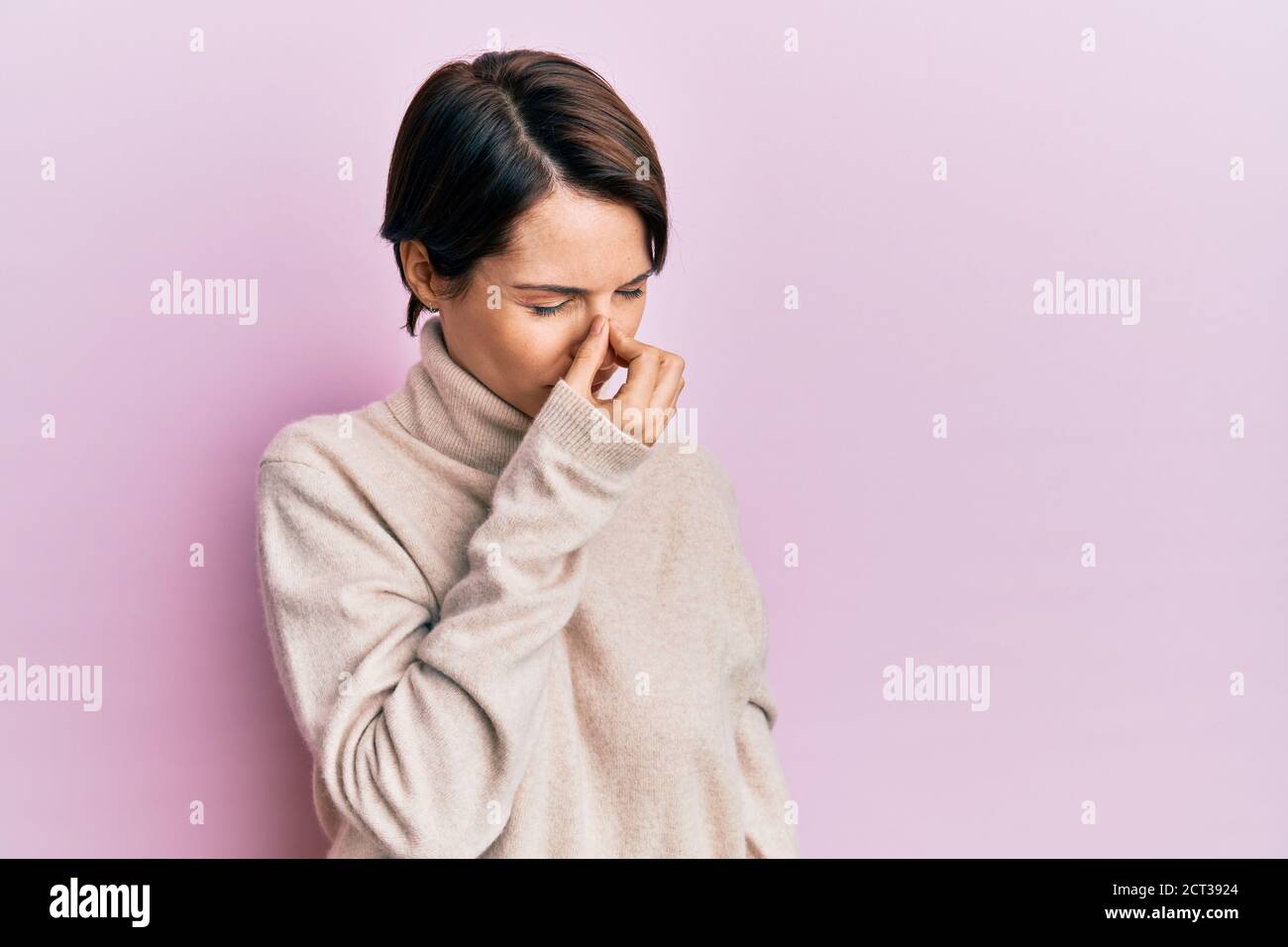Young brunette woman with short hair wearing casual winter sweater ...