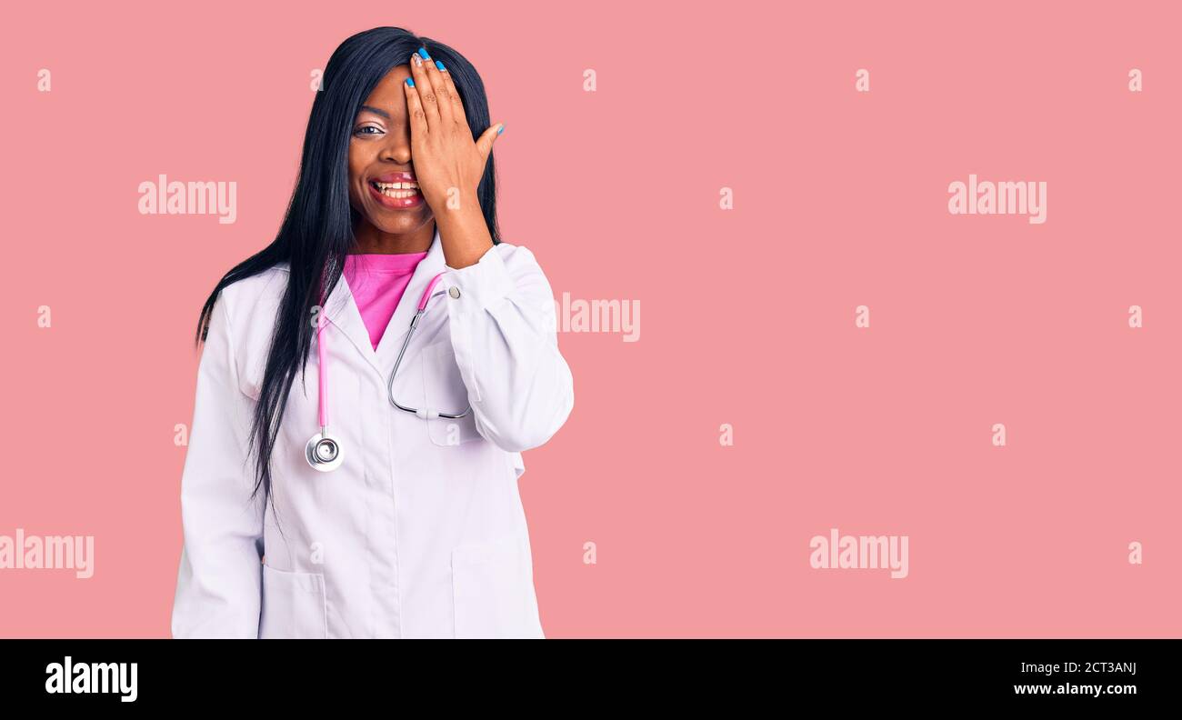Young african american woman wearing doctor stethoscope covering one ...