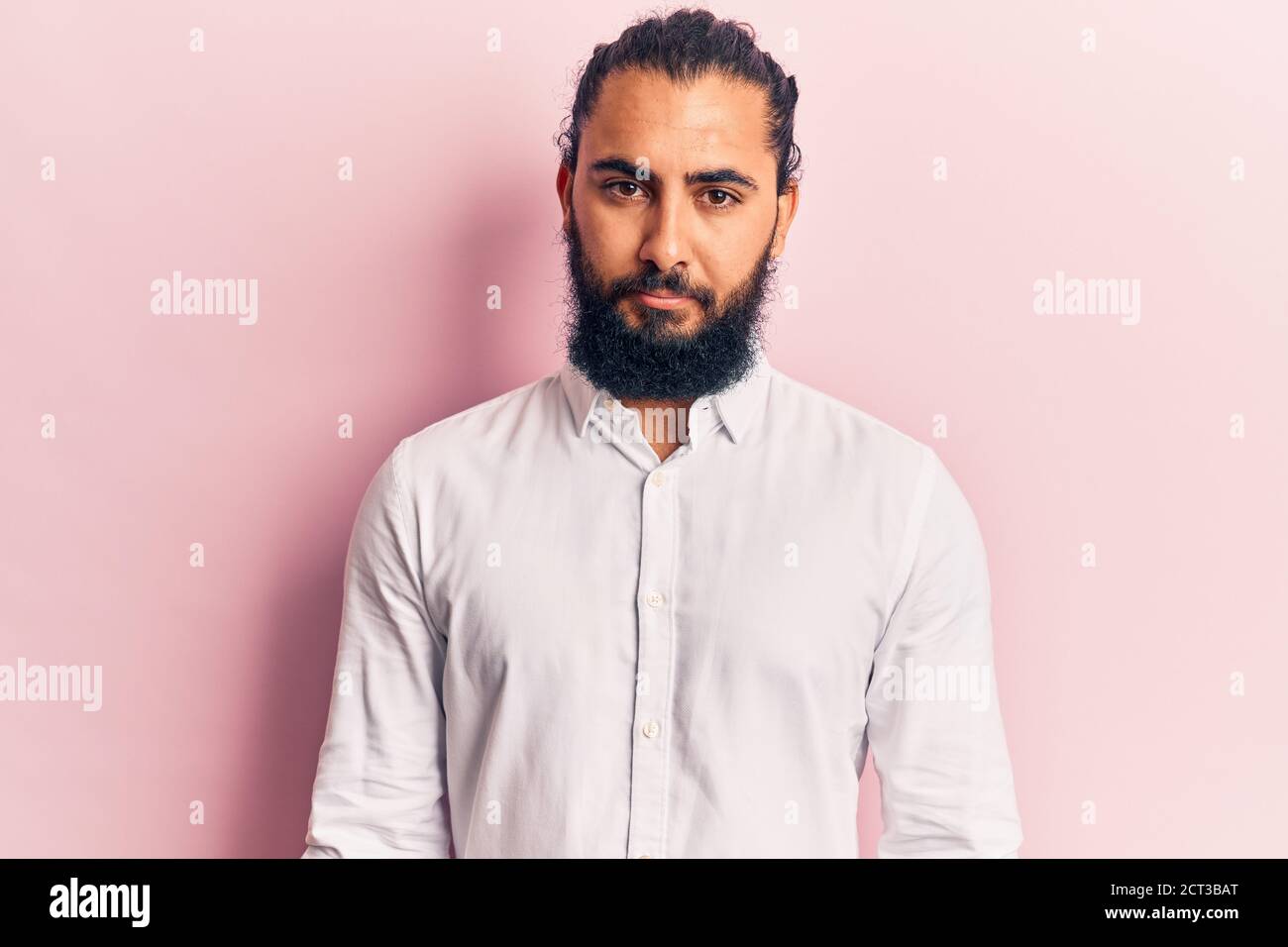 Young arab man wearing casual clothes depressed and worry for distress ...