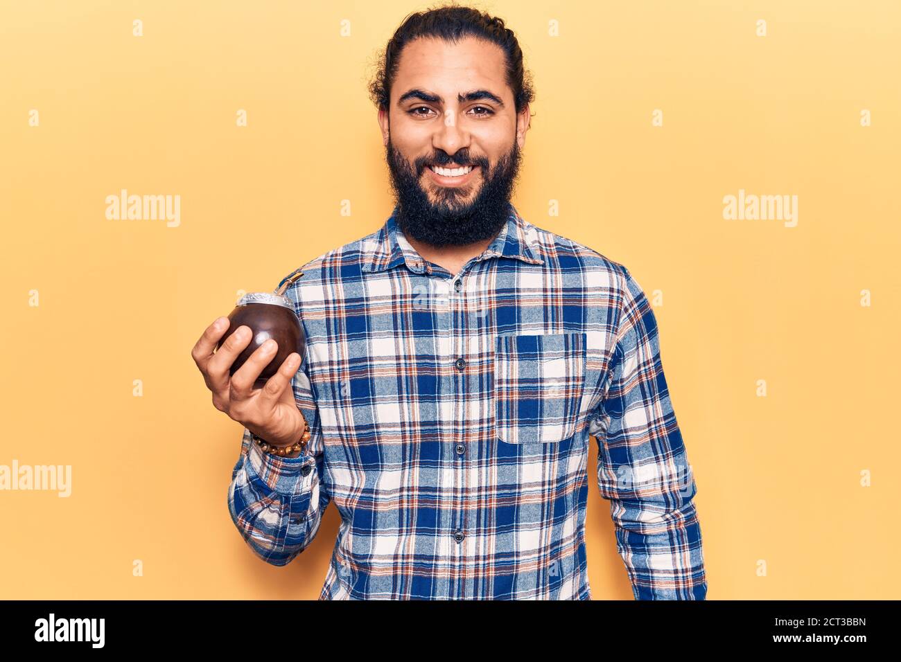 Young arab man drinking mate infusion looking positive and happy ...
