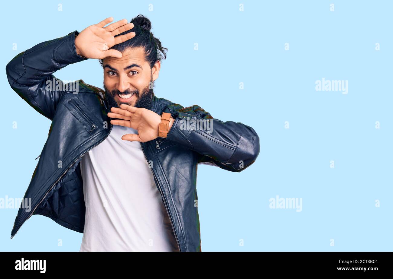 Young arab man wearing casual leather jacket smiling cheerful playing ...