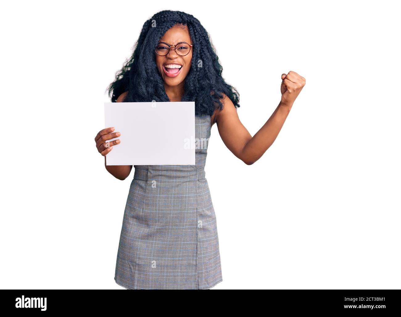 Beautiful african american woman holding blank empty banner screaming ...