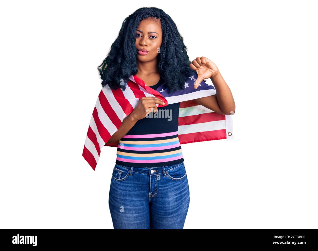 Beautiful african american woman holding united states flag with angry ...
