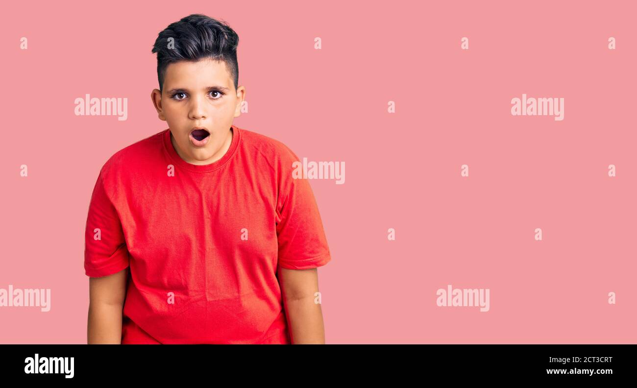 Little boy kid wearing casual clothes scared and amazed with open mouth ...