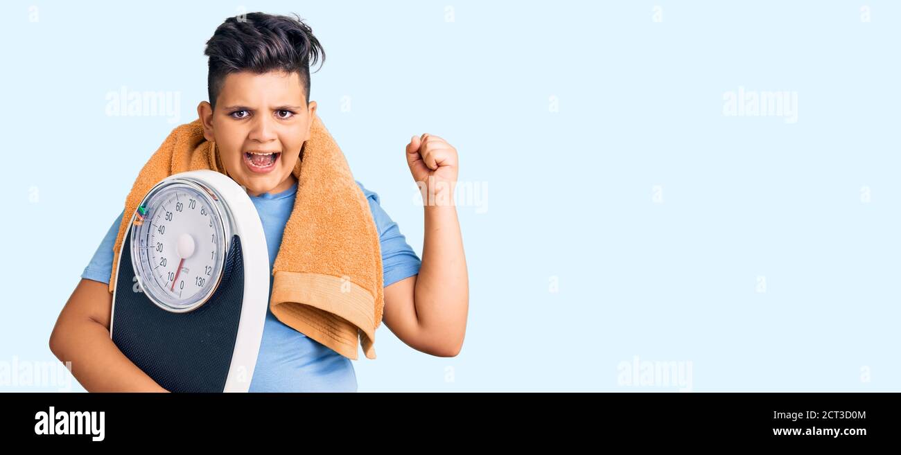 Little boy kid holding weight machine to balance weight loss screaming ...