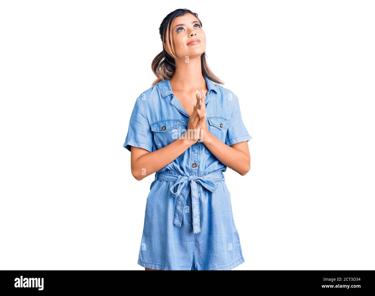Young beautiful woman wearing casual clothes begging and praying with ...