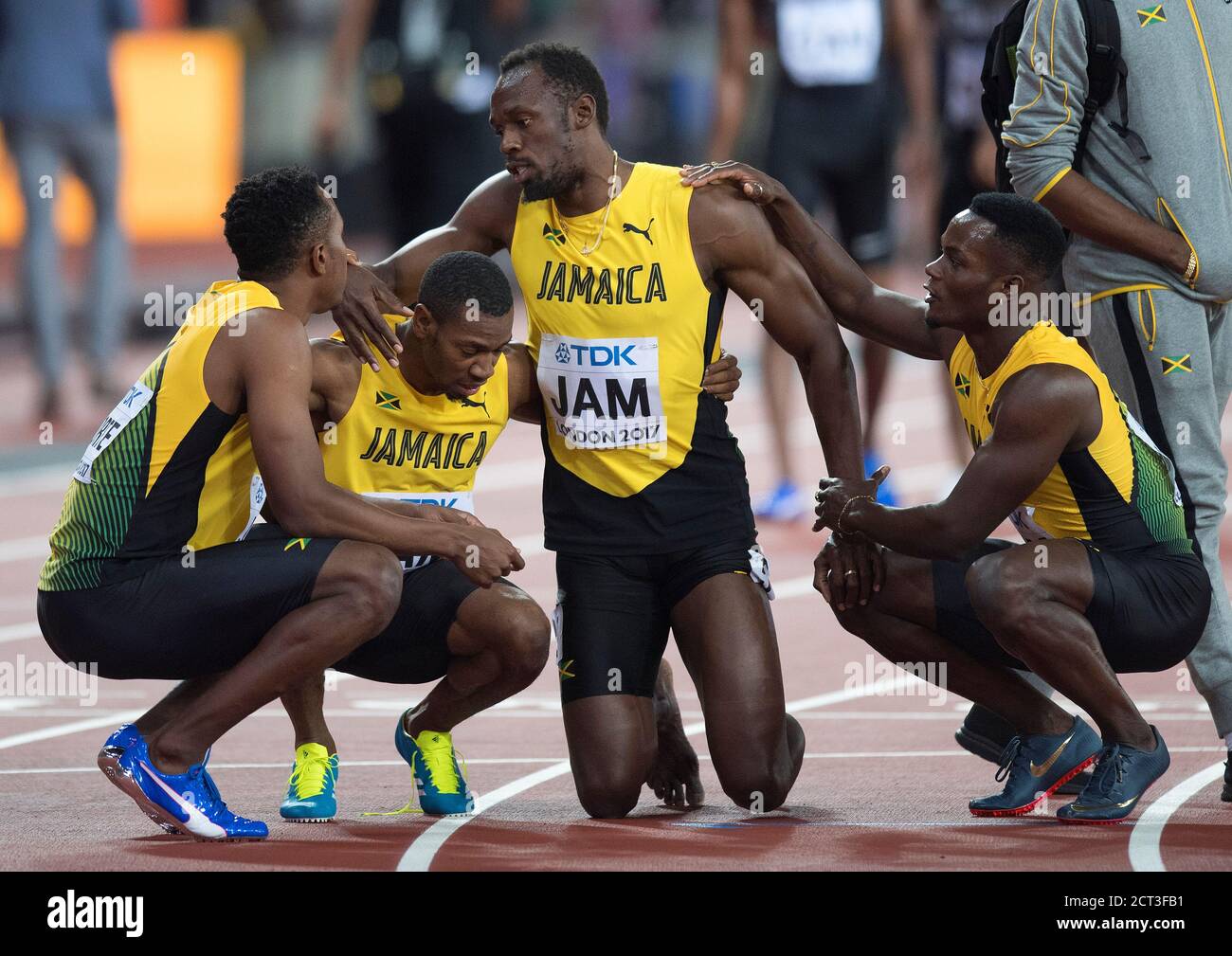 Usain Bolt is consoled by team-mates after pulling up injured in the ...