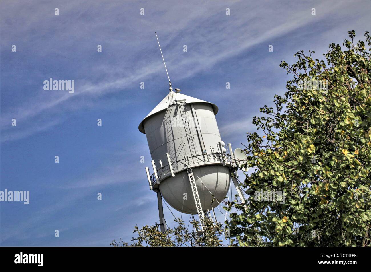White water tank on stilts in trees in the town during the drought of ...
