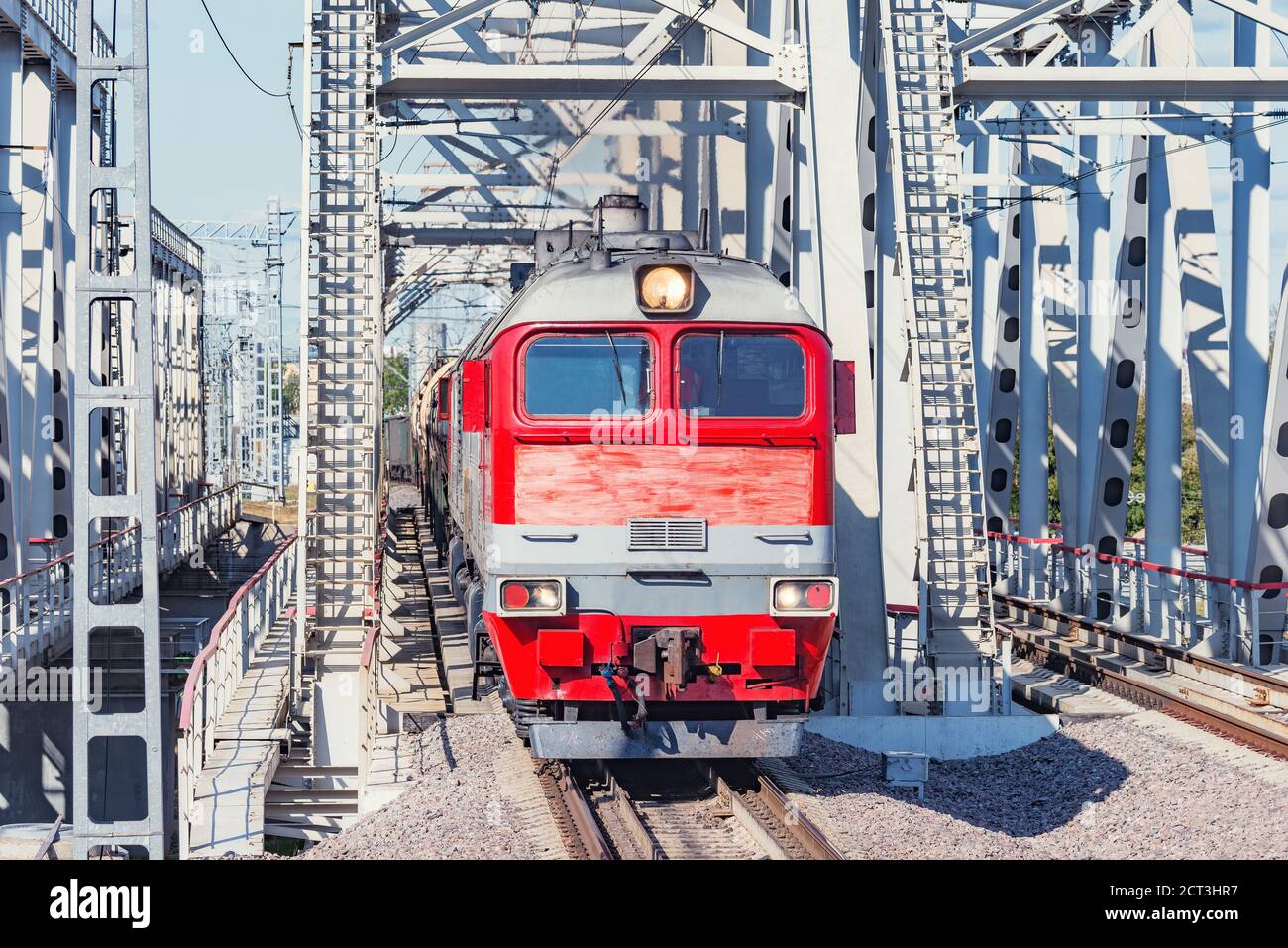 Diesel freight train moves through the bridge Stock Photo - Alamy