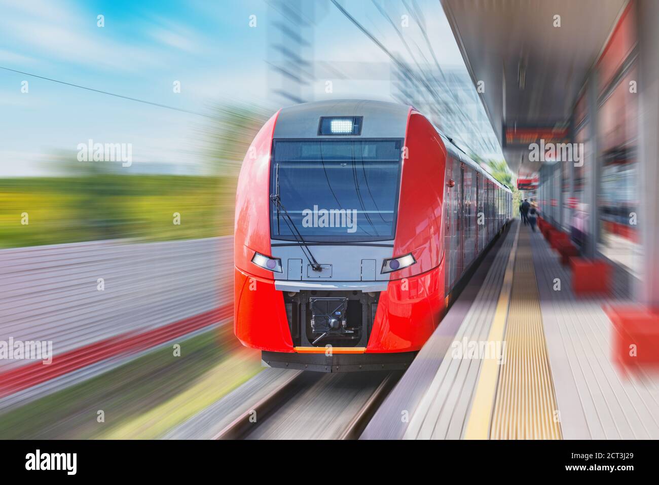 Highspeed train moves fast along the passenger platform Stock Photo - Alamy