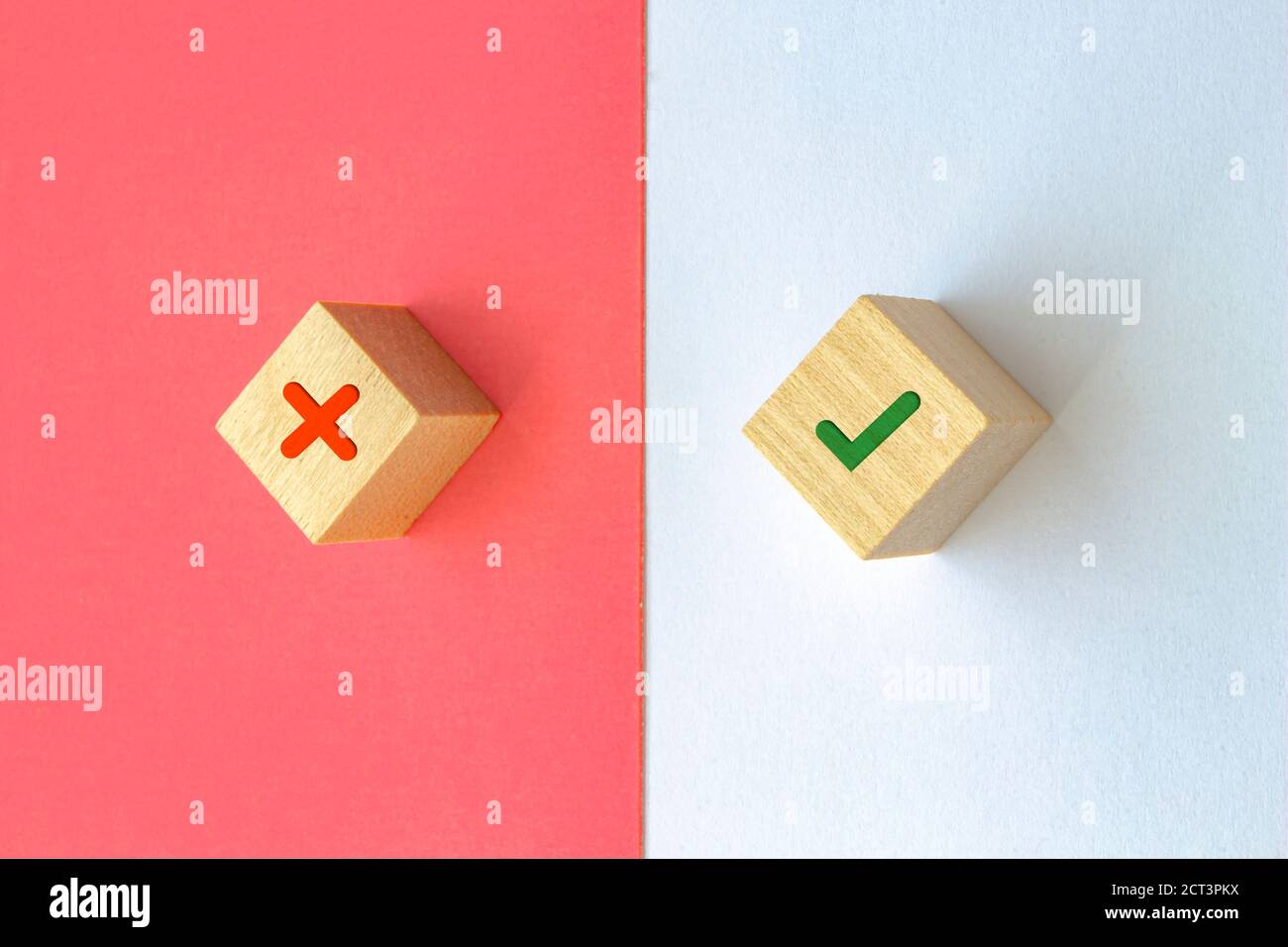 Wood cubes with an Ex and Check, wrong and right sign icons on a red ...