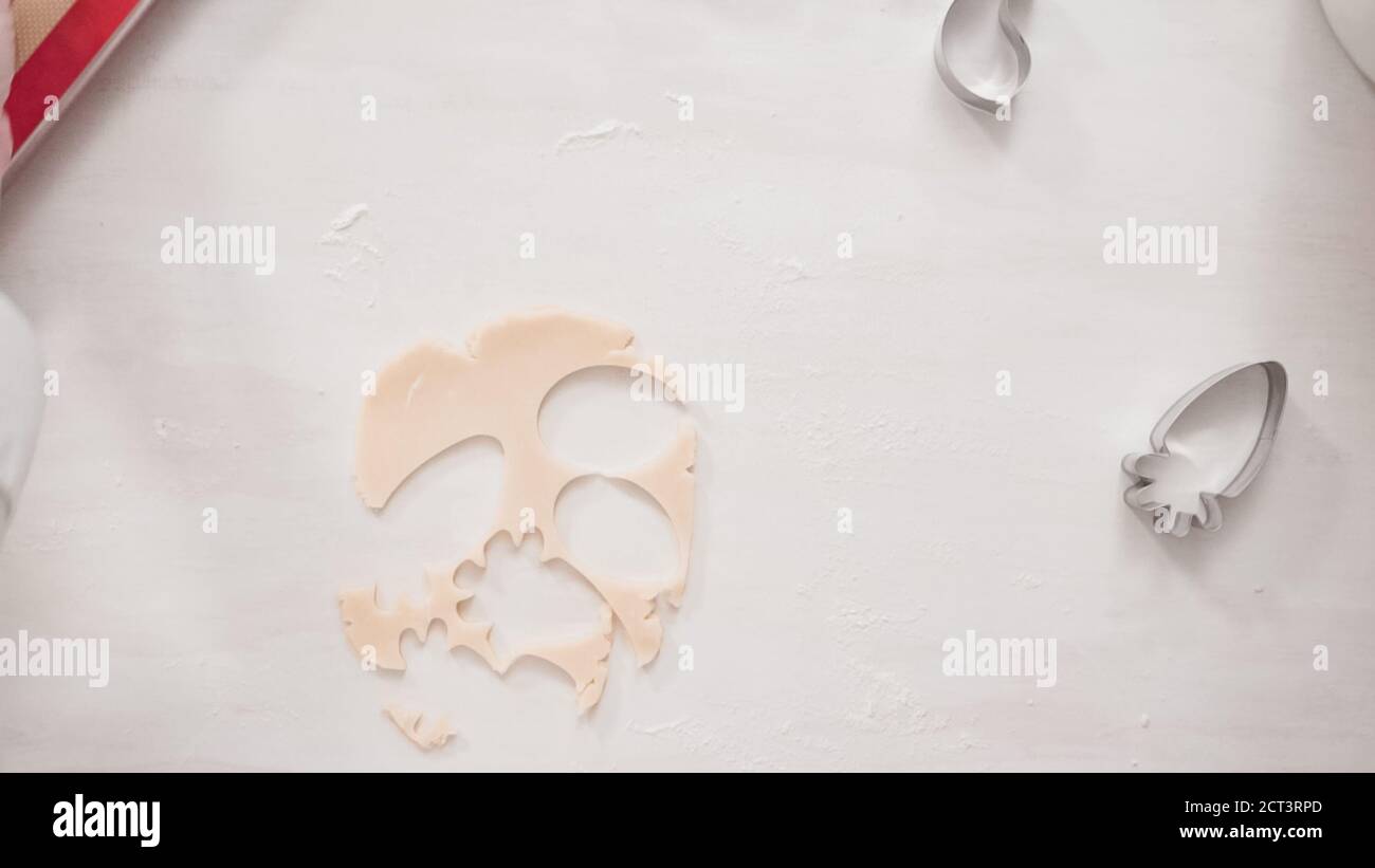 Step by step. Flat lay. Cutting sugar cookie dough with Easter shaped ...